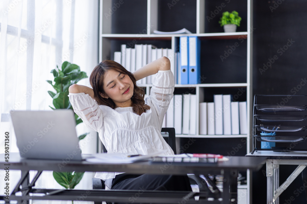 Tired Asian woman office employee staring at the laptop screen, feels ...