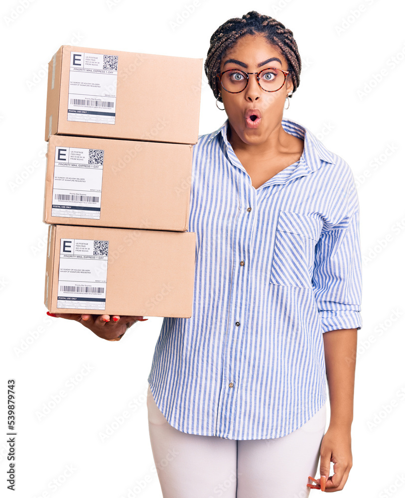 Young african american woman with braids holding delivery packages ...