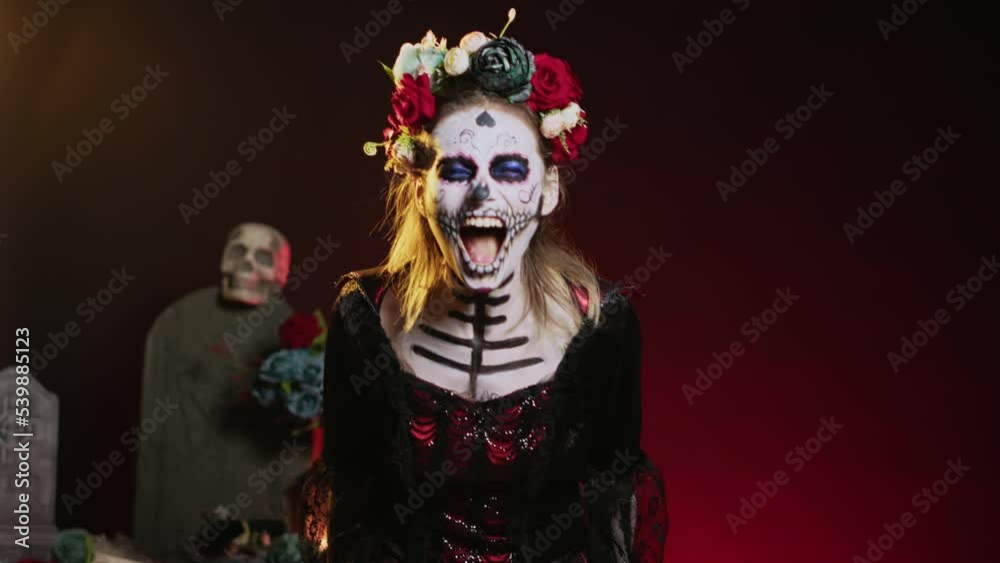 Scary dead woman screaming loud dressed in costume with skull body art ...