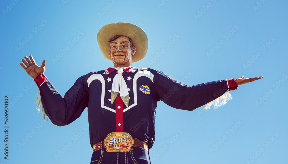 Closeup of the Big Tex statue. The figure icon greets and waves his ...