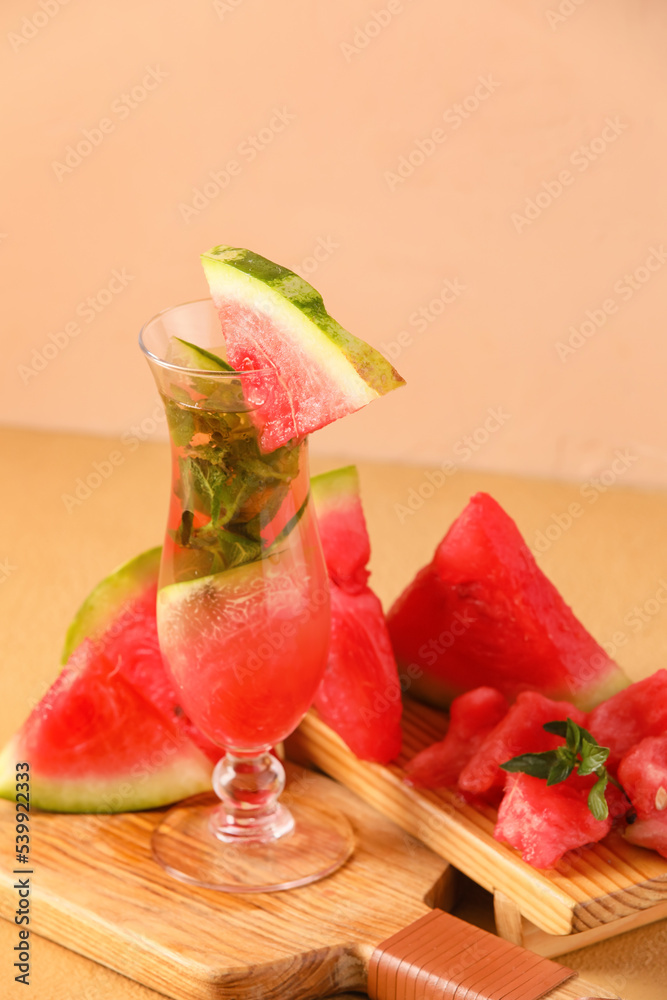 Board with glass of cold watermelon fresh on color background, closeup ...