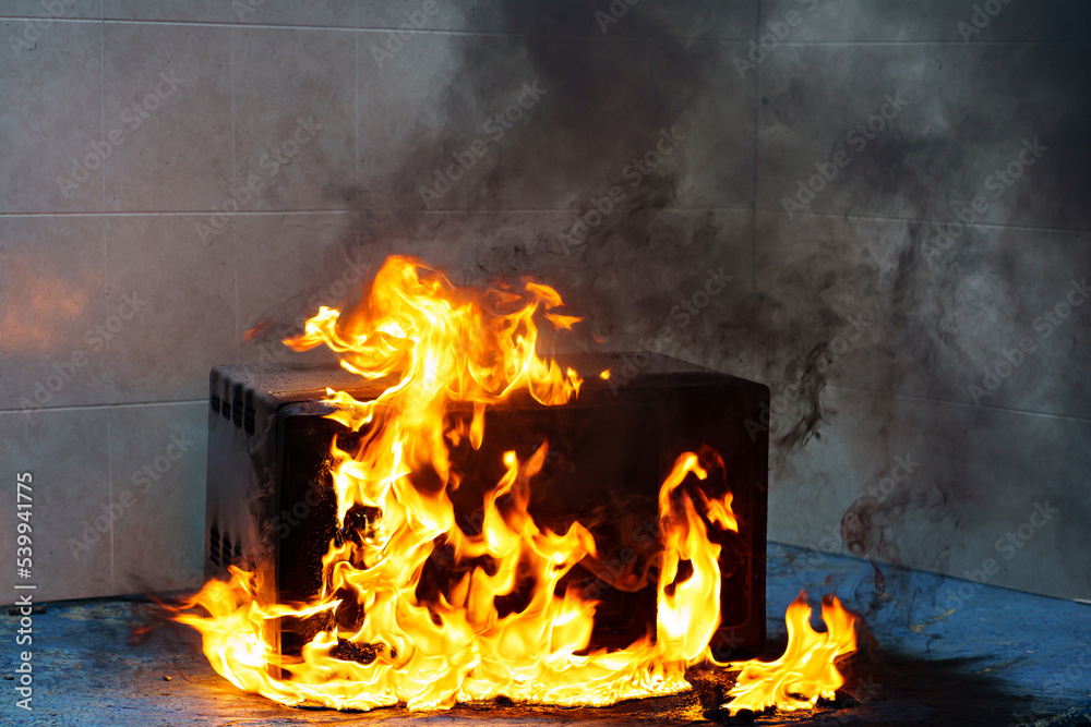 microwave oven on fire. the concept of fire in the kitchen and ...
