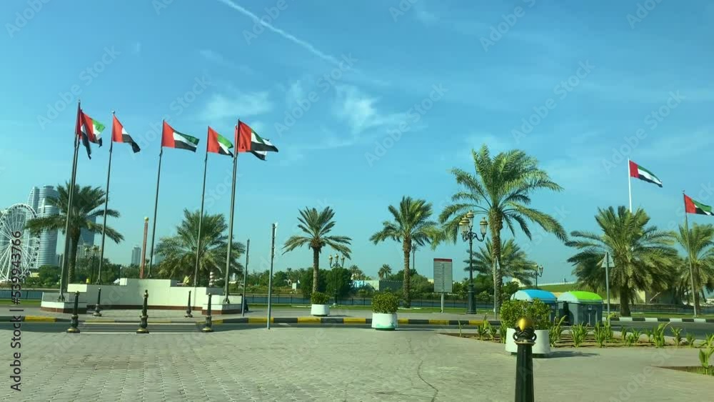 National symbol of United Arab Emirates flags in blue sky background ...