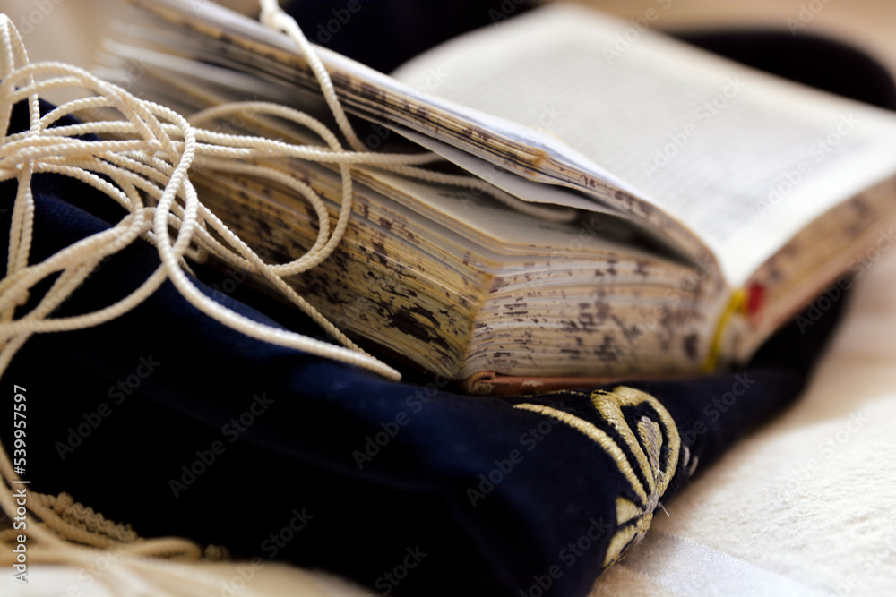 An ancient jewish siddur on a Prayer shawl - Tallit Jewish and a ...