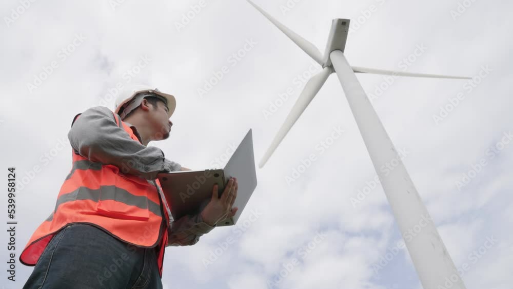 Engineer working on a wind turbine with the sky background. Progressive ...