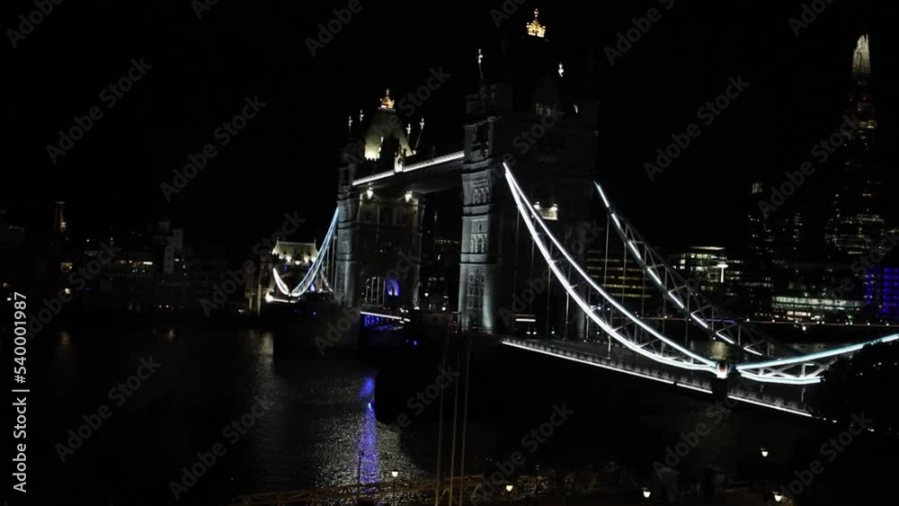 the infamous Tower Bridge and the Shard illuminated with bright lights ...