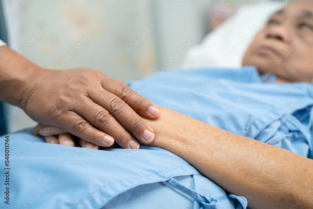 Doctor holding touching hands Asian senior or elderly old lady woman ...