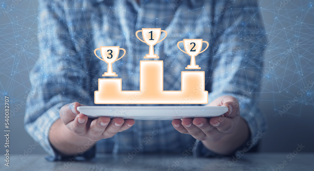 Human hand showing winners podium with three winning cups. Stock Photo ...