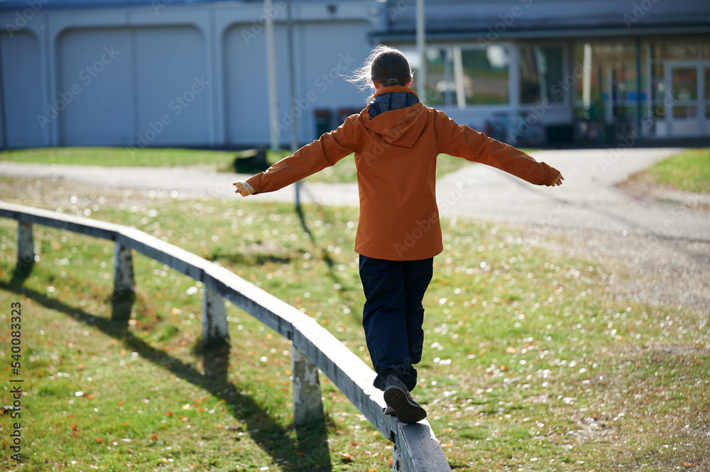 Child balancing on a board Stock Photo | Adobe Stock