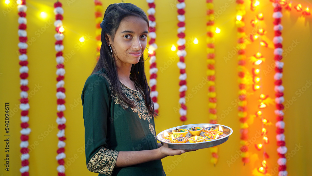 Diwali Hindu Festival of lights celebration. Diya or oil lamp in woman ...