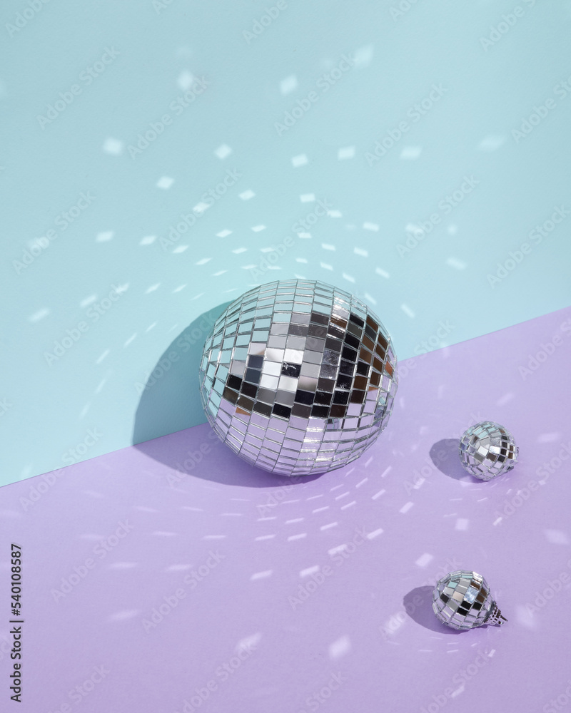 Creative minimal still life with mirrored disco balls on pastel ...