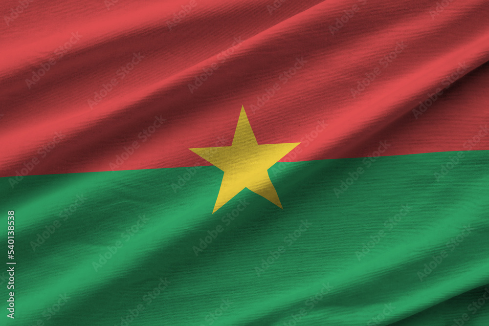 Burkina Faso flag with big folds waving close up under the studio light ...