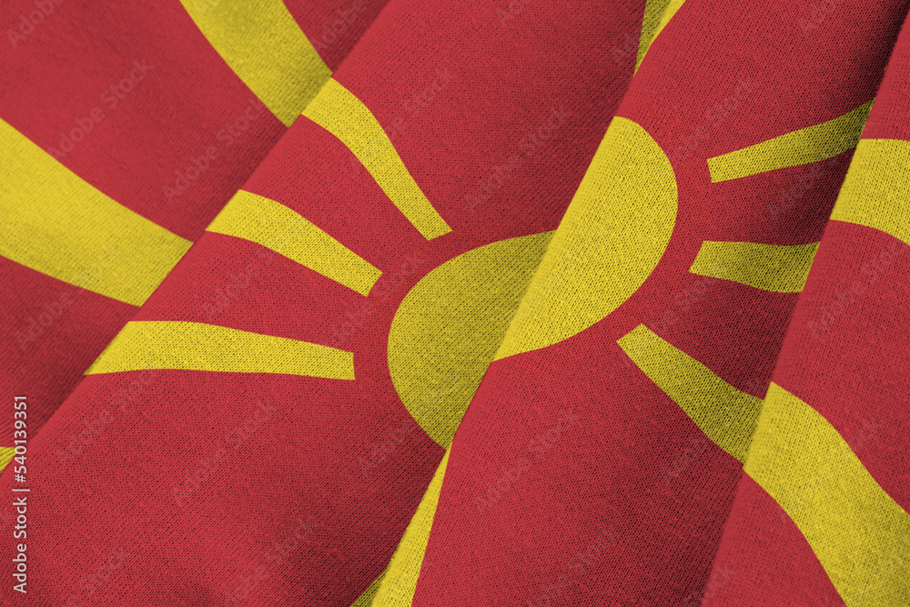 Macedonia flag with big folds waving close up under the studio light ...