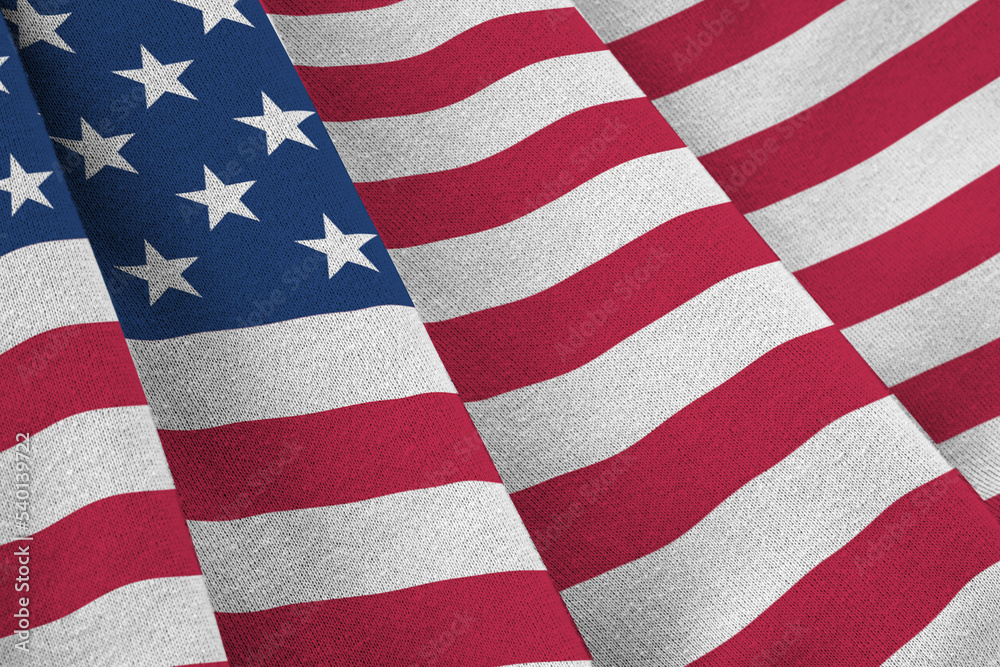 United States of America flag with big folds waving close up under the ...