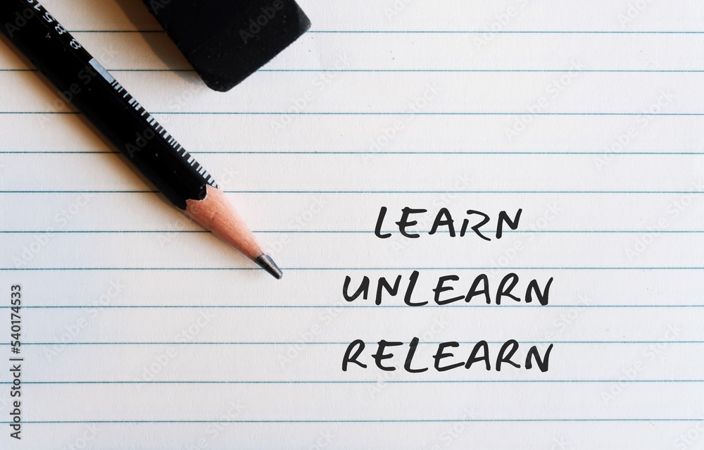 Pencil eraser on paper background with handwritten text Learn Unlearn ...
