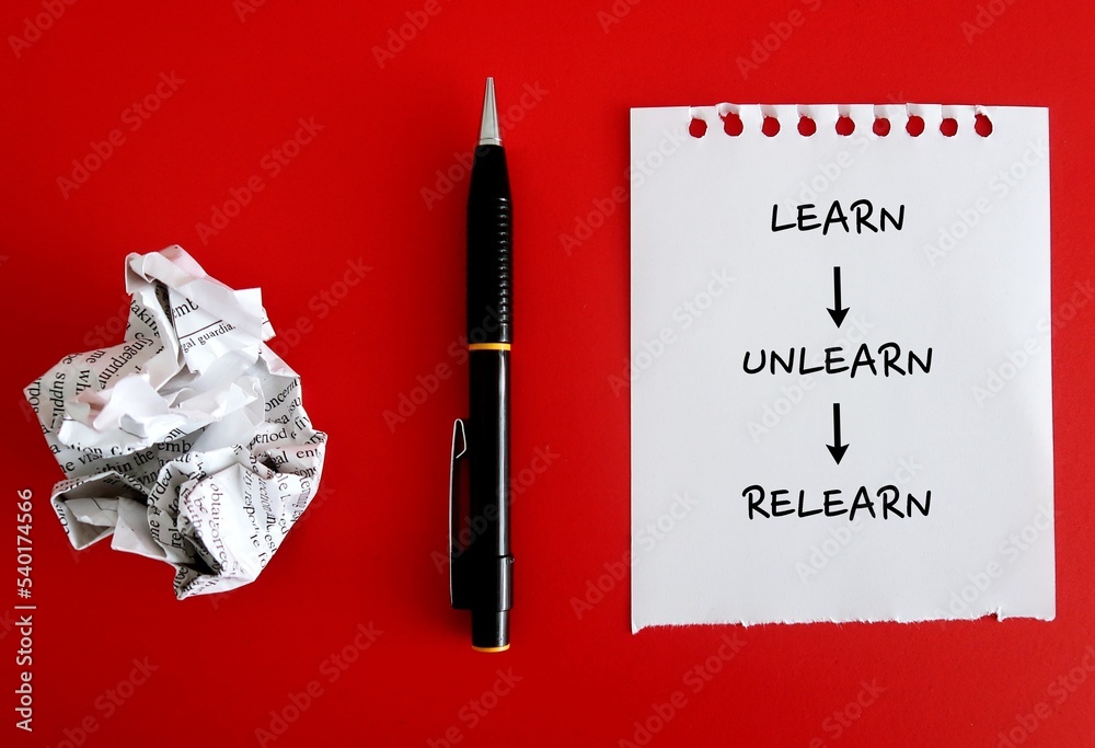 Pen ,crumpled paper and note paper on red background with handwritten ...