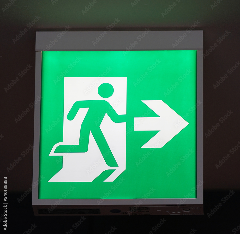 Glowing green emergency exit signs indoors in Japanese buildings Stock ...