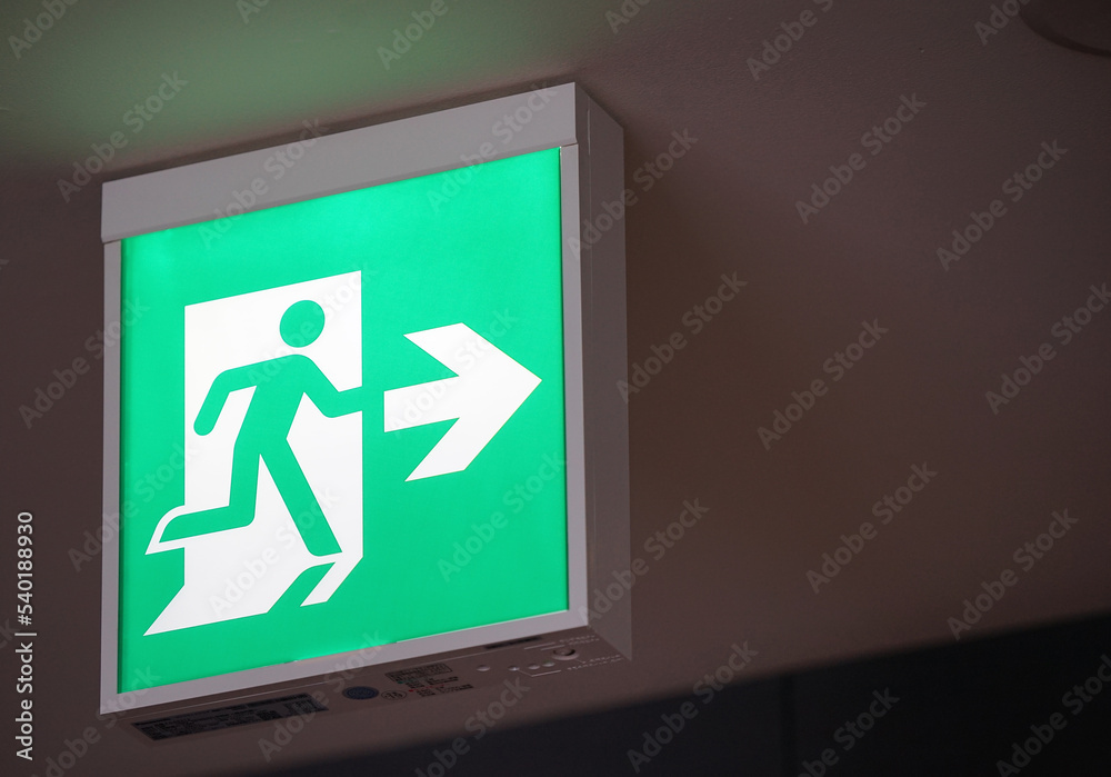 Glowing green emergency exit signs indoors in Japanese buildings Stock ...