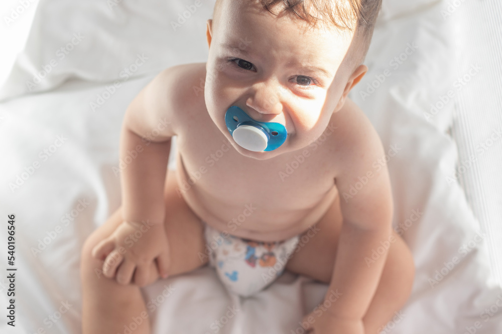 unhappy upset crying baby toddler infant toddler with pacifier in mouth ...