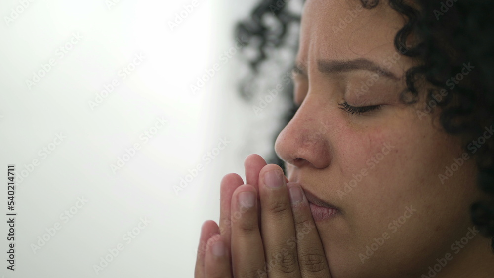 One spiritual young black woman face in prayer. Meditative ...
