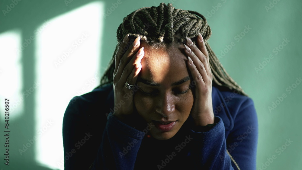 Desperate young woman in crisis at home. African American woman ...