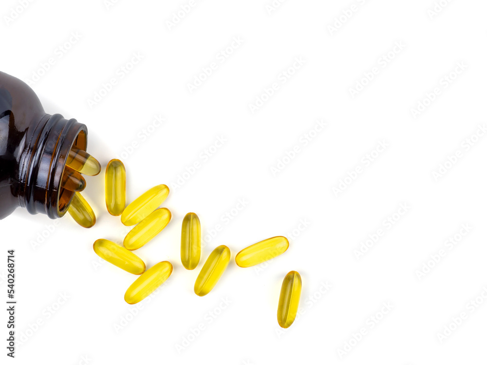 fish oil capsules spilling out from the bottle. Soft gelatin capsule ...