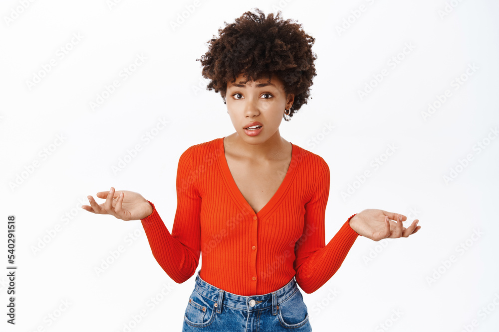 Image of confused african american woman shrugs shoulders, looks ...