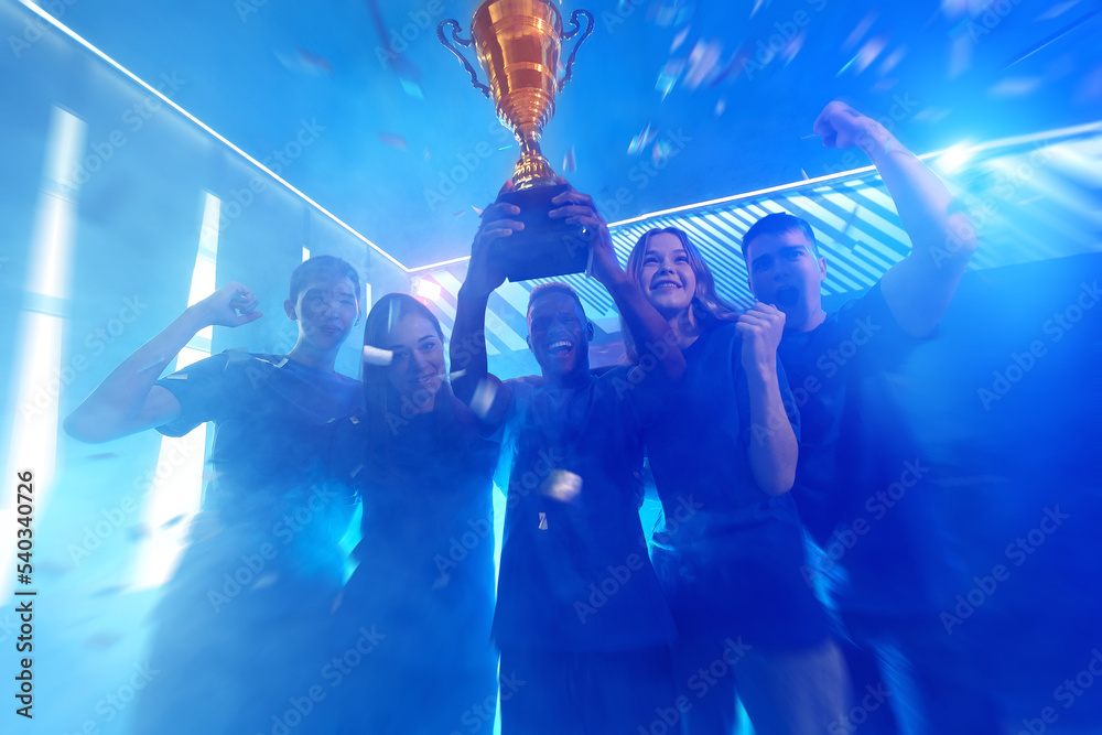Concept cyber gaming esport. Winner team gamer holding cup trophy prize ...