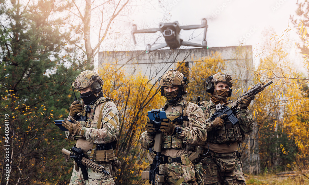 Modern army soldiers using aerial drone for artillery guidance and ...