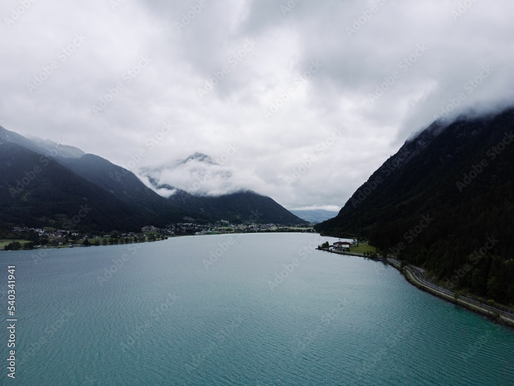 Aerial of Achen lake in Achensee region surrounded by green mountains ...