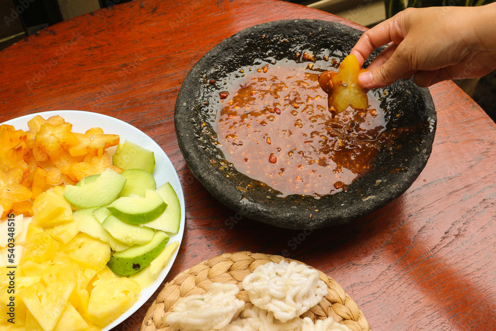Hand pick starfruit of Lotis buah or rujak. fruits with hot chili paste ...