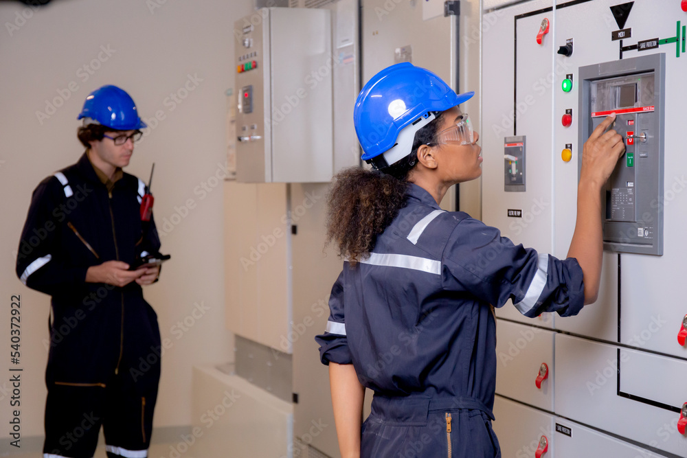 Electrical young asian woman and man engineer examining maintenance ...