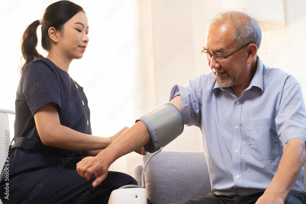 Pressure measurement of hypertension in elderly man sitting on couch ...