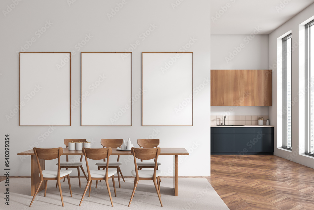 Light kitchen interior with dining table and seats, cooking area ...