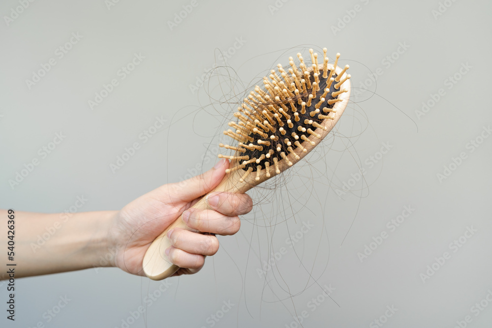 Hair fall problem concept. Shocked Asian woman looking at many hair ...