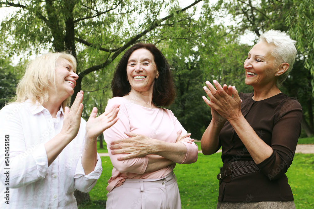 Foto de Women friends in the park celebrate a birthday. Clap your hands ...