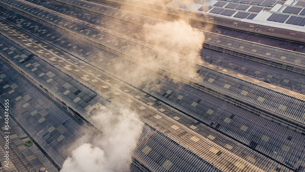 Toxic fumes spread from the roof of an industrial plant. Industrial ...