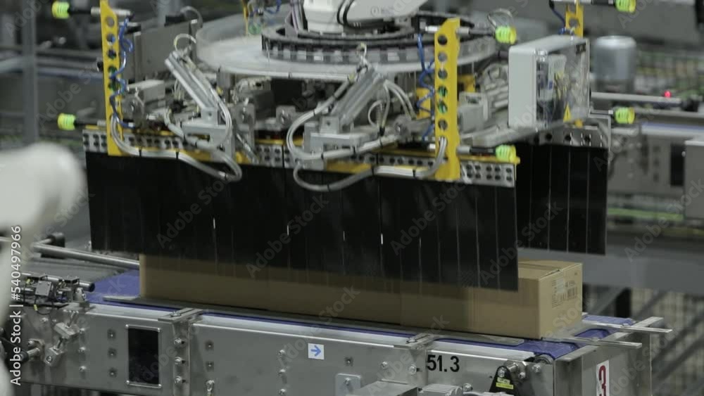 Automatic robot sorting carton boxes from a conveyor belt to a box in a ...