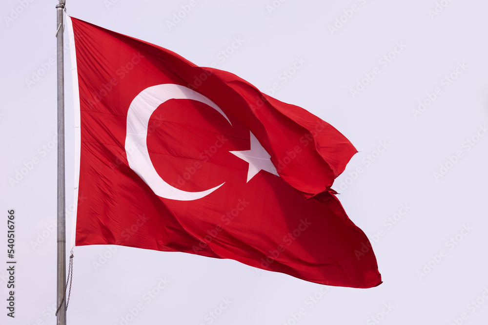 Turkish flag, on a red background white star and moon. Flag flies in ...