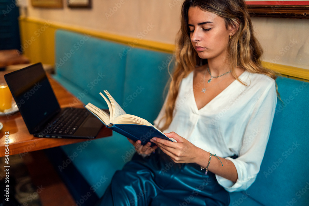 Young girl reading and preparing homework from a coffee shop. Stock ...