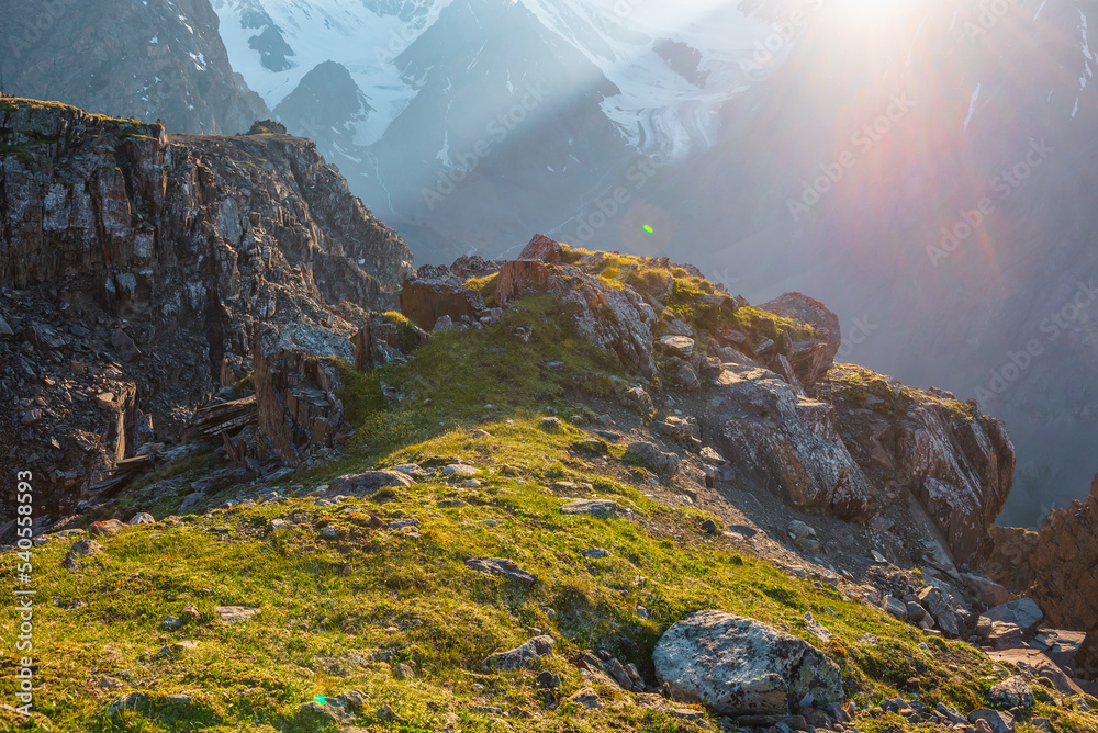 Sunny mountain view from cliff at very high altitude. Scenic alpine ...