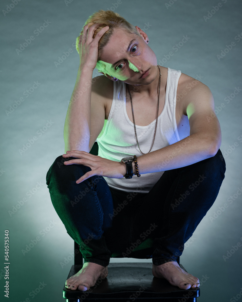 Non-Binary citizen with short cropped blonde hair, wearing black jeans ...