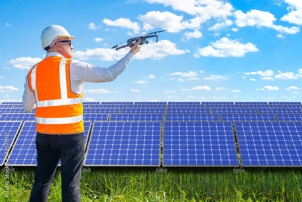 Solar eco farm. Man solar power plant engineer with quadcopter. Power ...