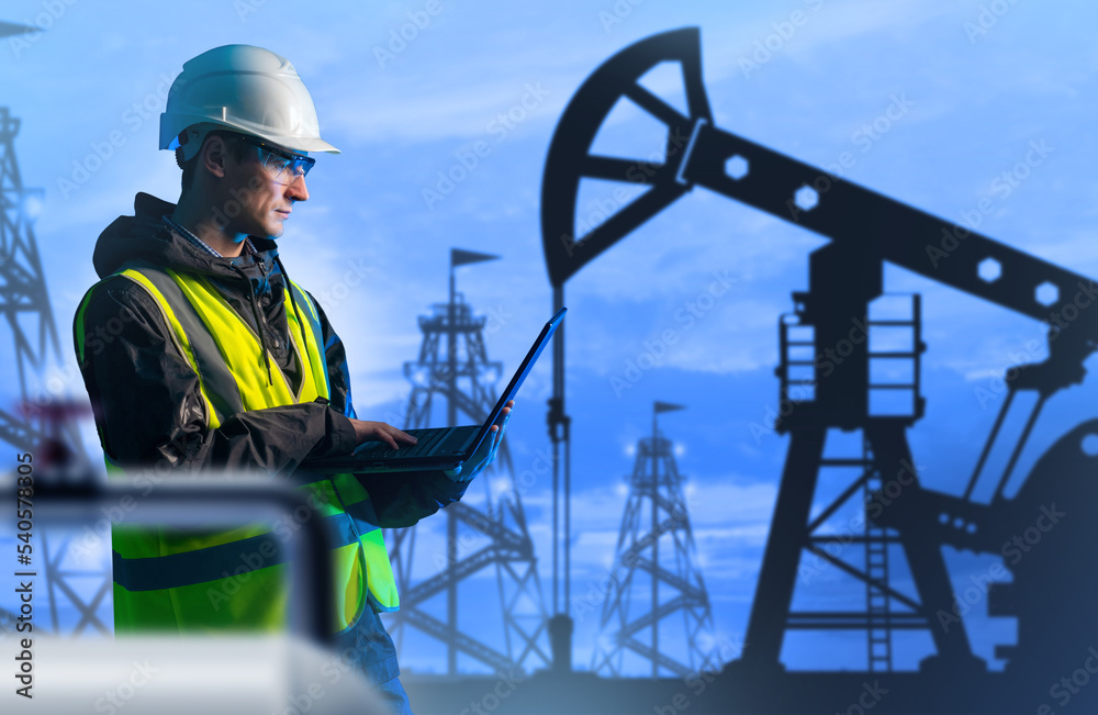 Employee of oil refinery. Man with laptop. Man controls oil production ...