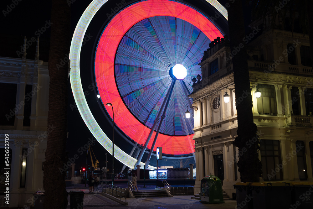 Large wheel view at night in an urban environment at a long shutter ...