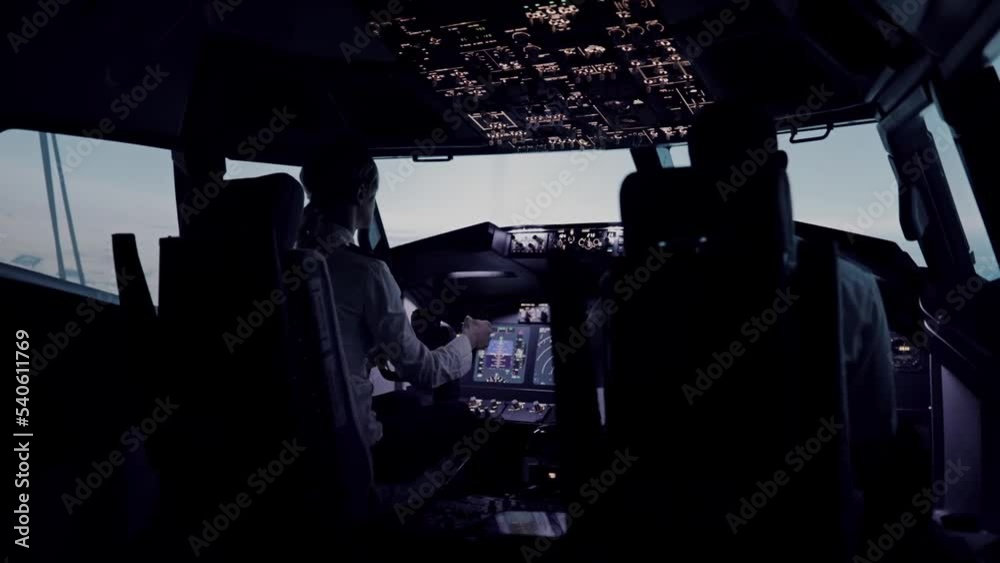 A woman pilot is flying in the cockpit. Pilots talking in the cockpit ...