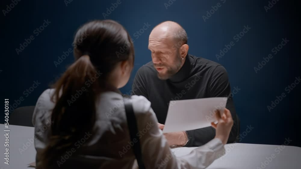 Female detective shows to suspected criminal photo of evidence from ...