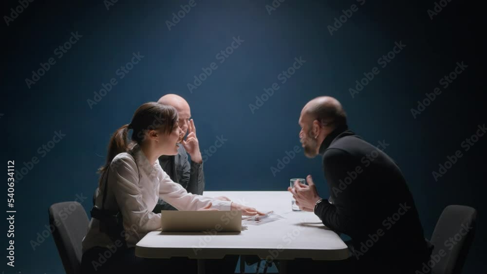 2 Police officers interrogate murder suspect. Detective cop shows knife ...