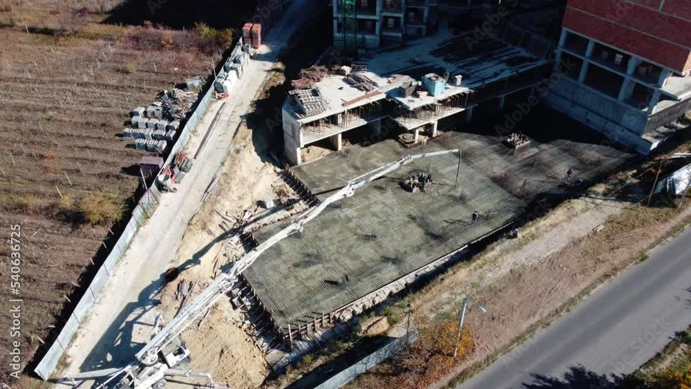 Concreting of reinforced concrete slab. Worker concretes foundation ...