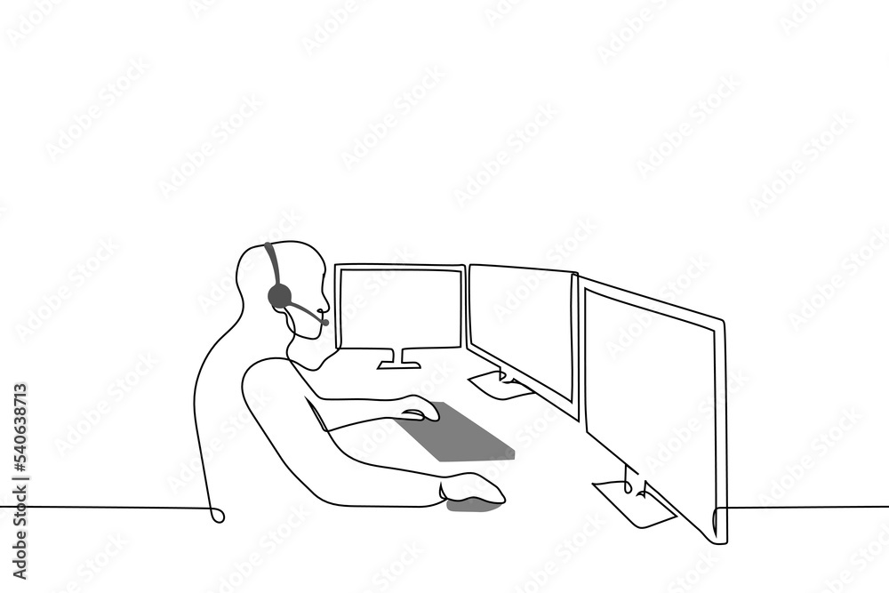 man sitting in front of multiple monitors and wearing headphones with ...